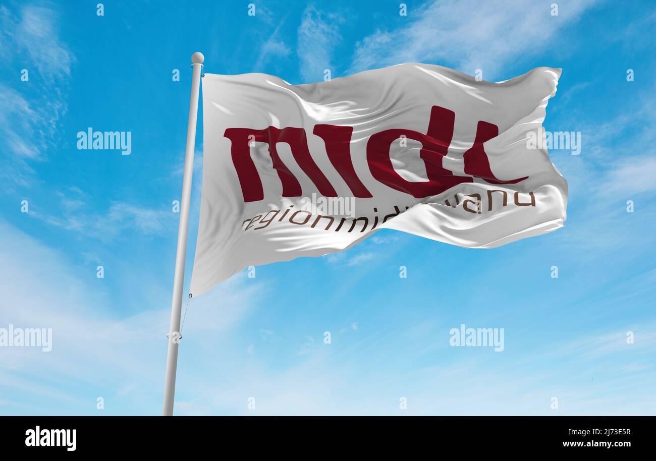 official flag of Region Midtjylland , Denmark at cloudy sky background ...