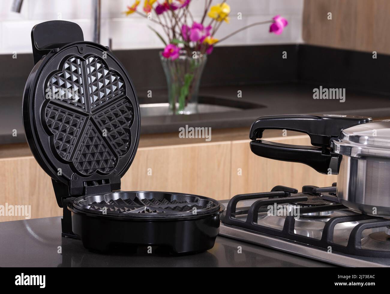 Modern electric waffle maker - Kitchen background Stock Photo - Alamy