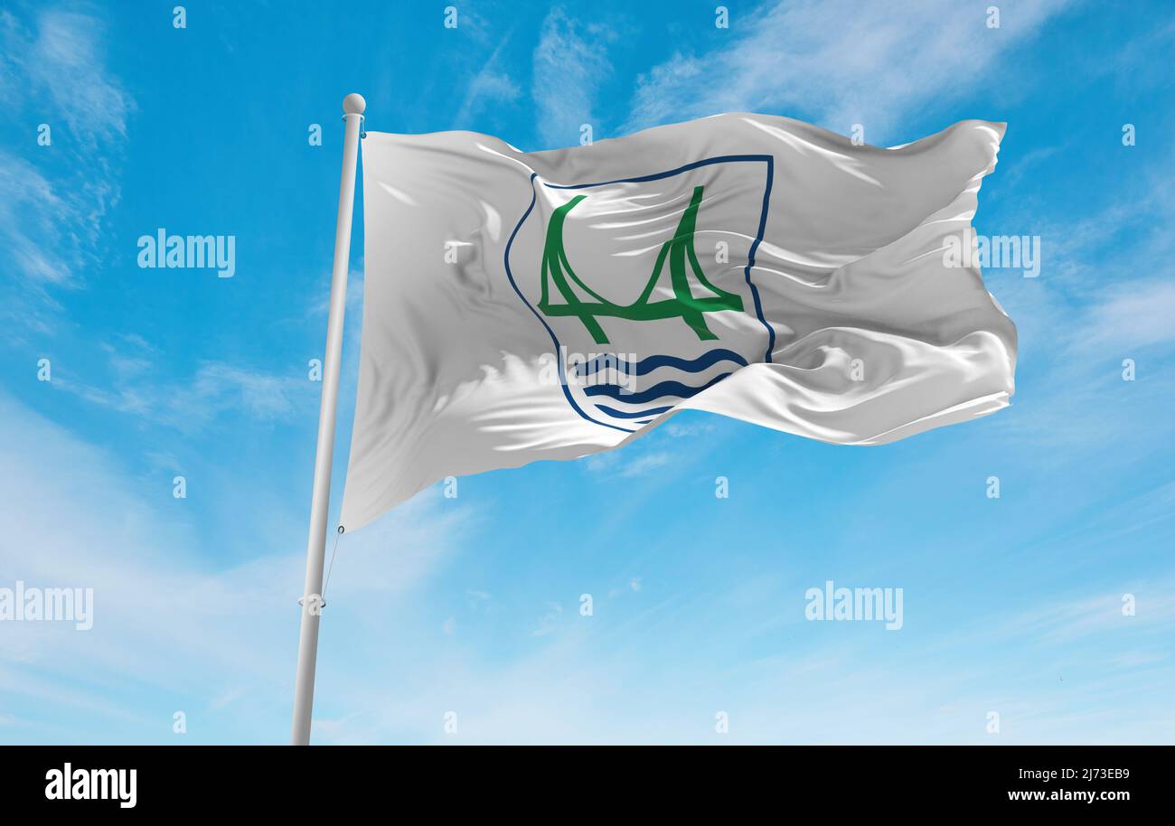 official flag of Slagelse Kommune , Denmark at cloudy sky background on ...