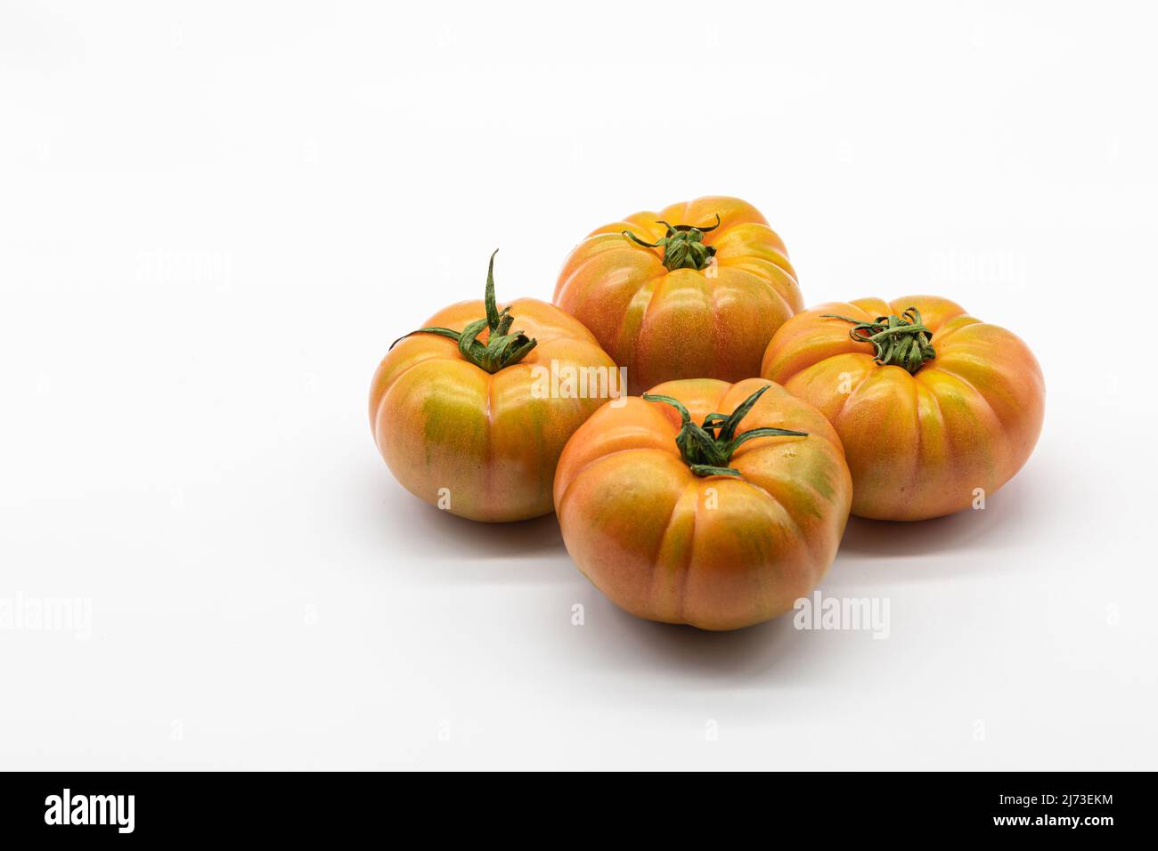 Four red tomatoes for salad isolated on a white background Stock Photo ...