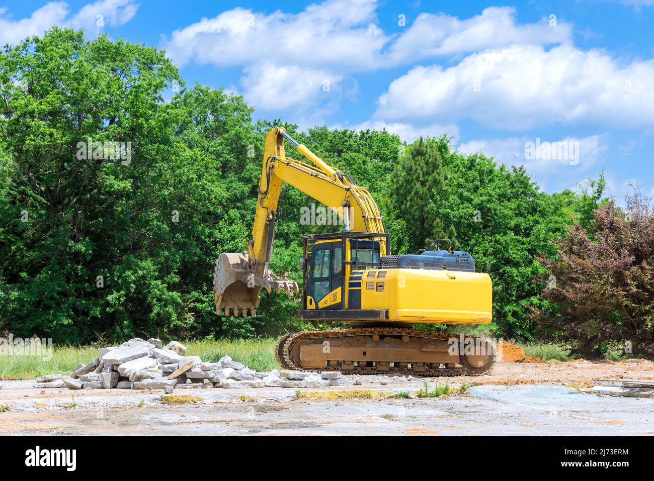 Backhoe excavator scoop loading from building the construction debris ...