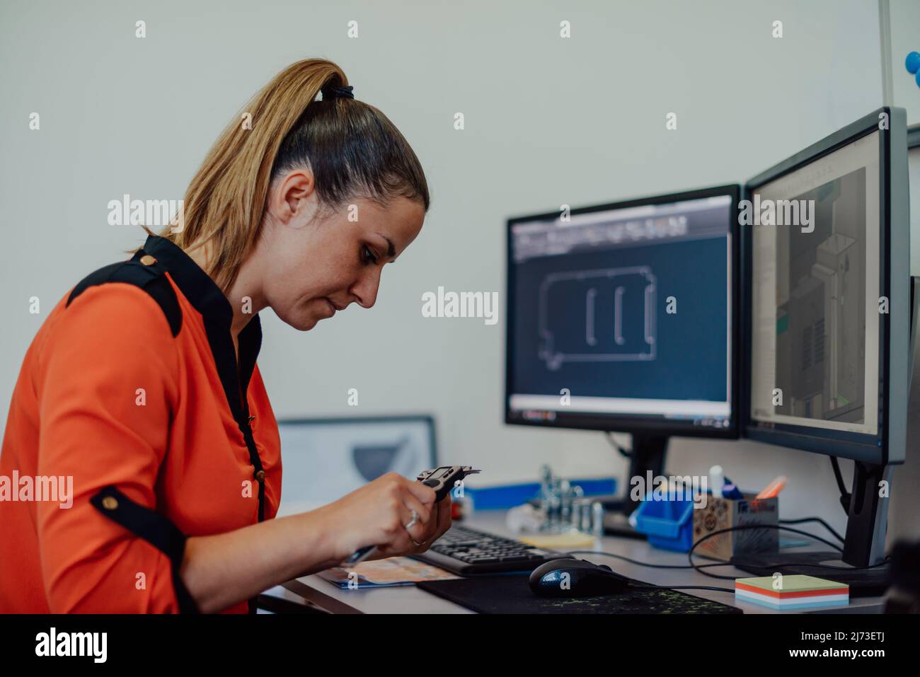 Within the heavy industry, a factory industrial engineer measures with ...