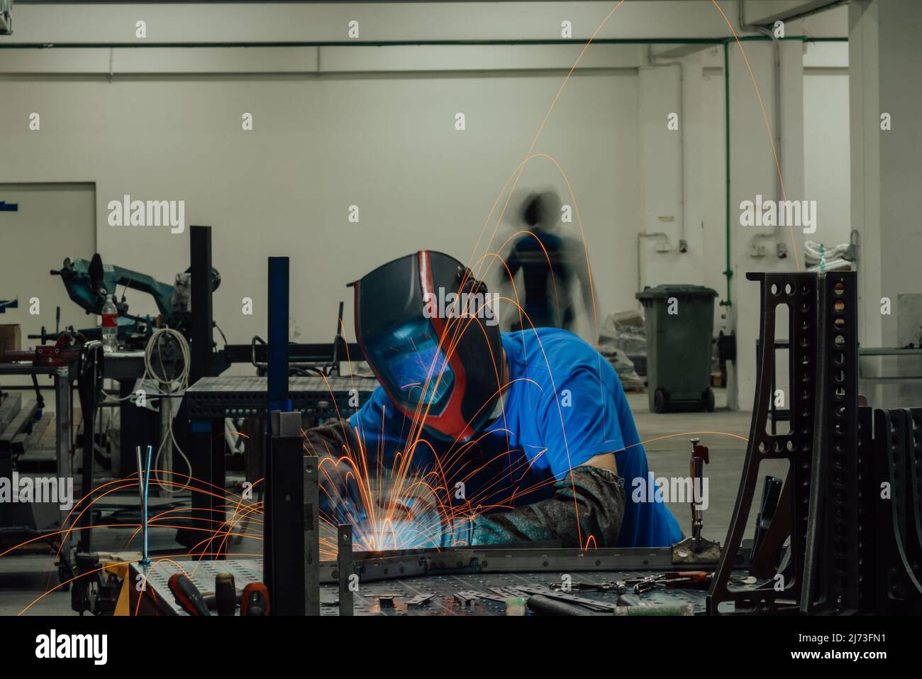 Professional Heavy Industry Welder Working Inside factory, Wears Helmet ...