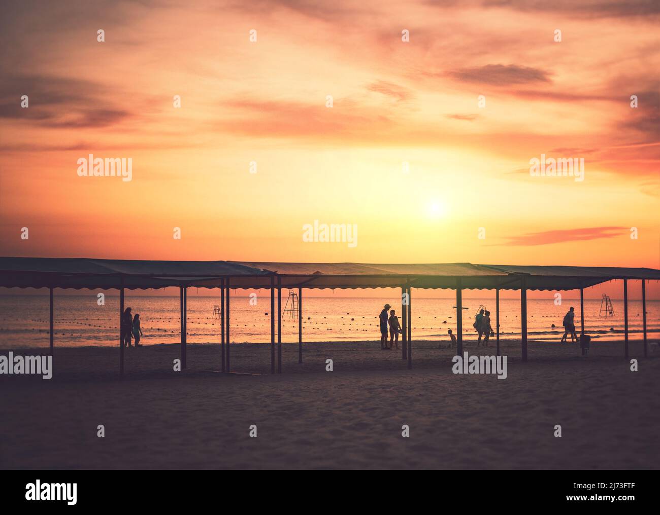 people at sunset resort beach Stock Photo - Alamy