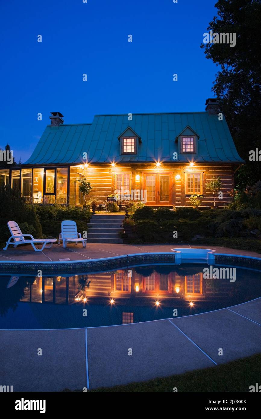 Rear view of old 1800s two-storied Canadiana style log home with ...