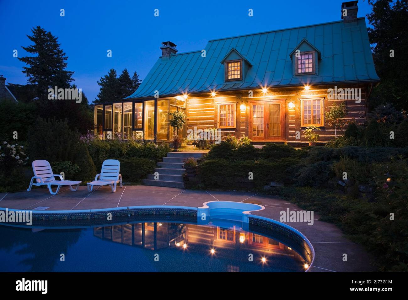 Rear view of old 1800s two-storied Canadiana style log home with ...