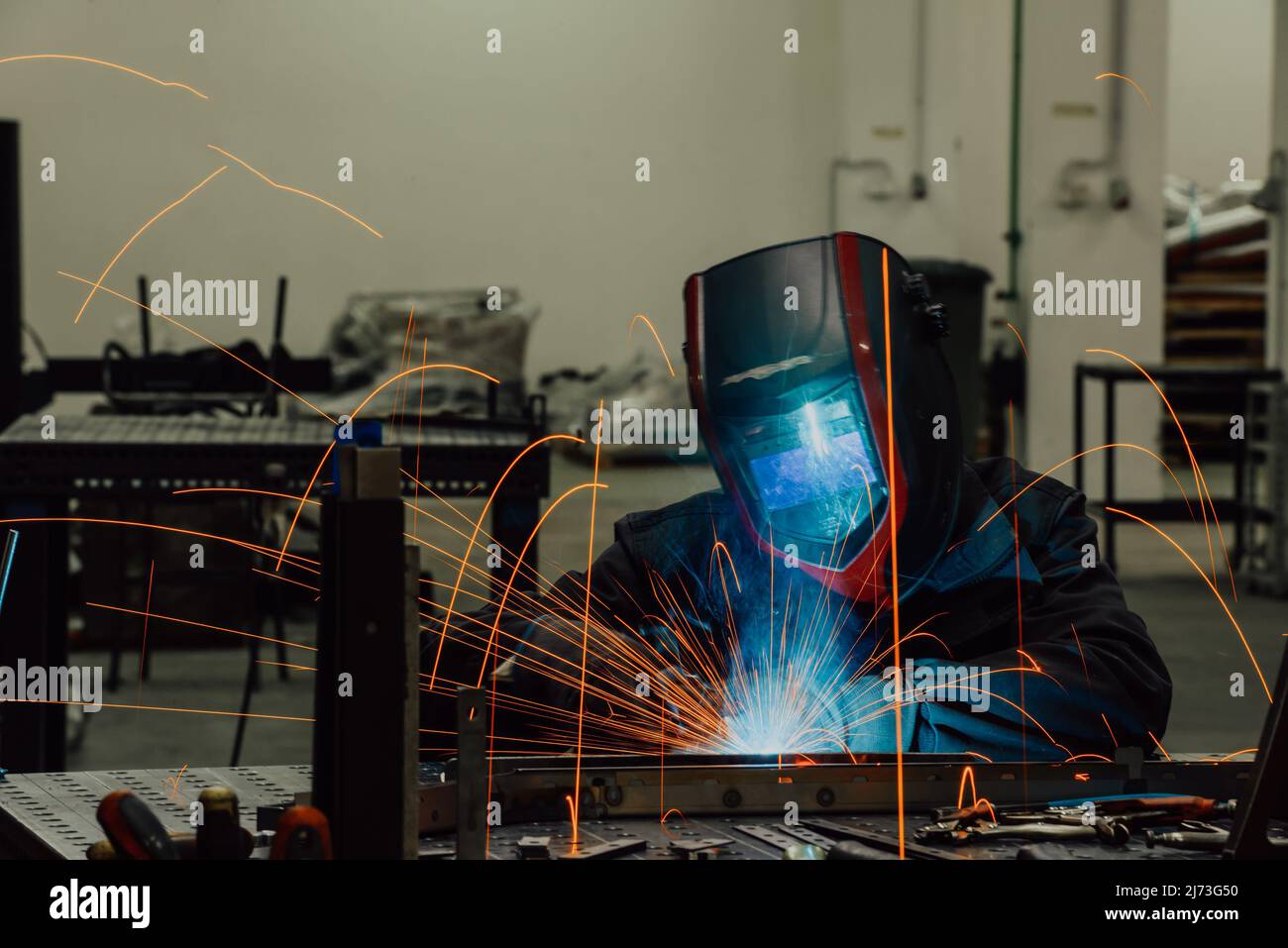 Professional Heavy Industry Welder Working Inside factory, Wears Helmet ...