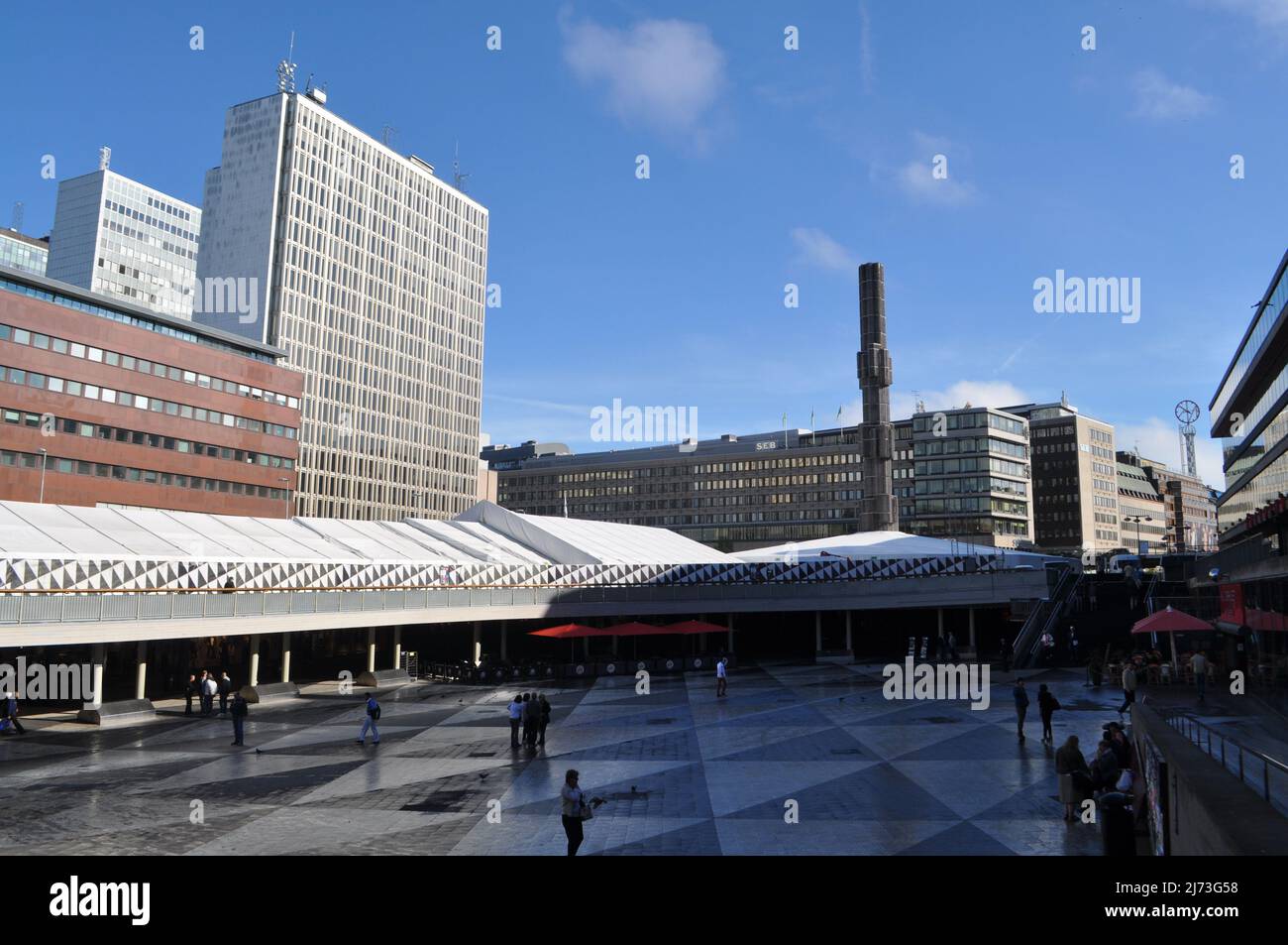 People walking on the street amid a landscape of functional modern ...