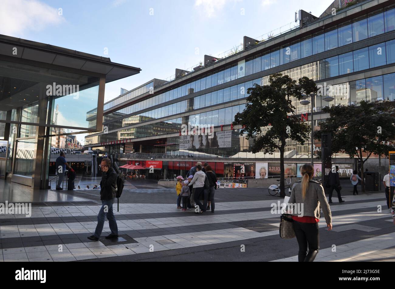 People walking on the street amid a landscape of functional modern ...