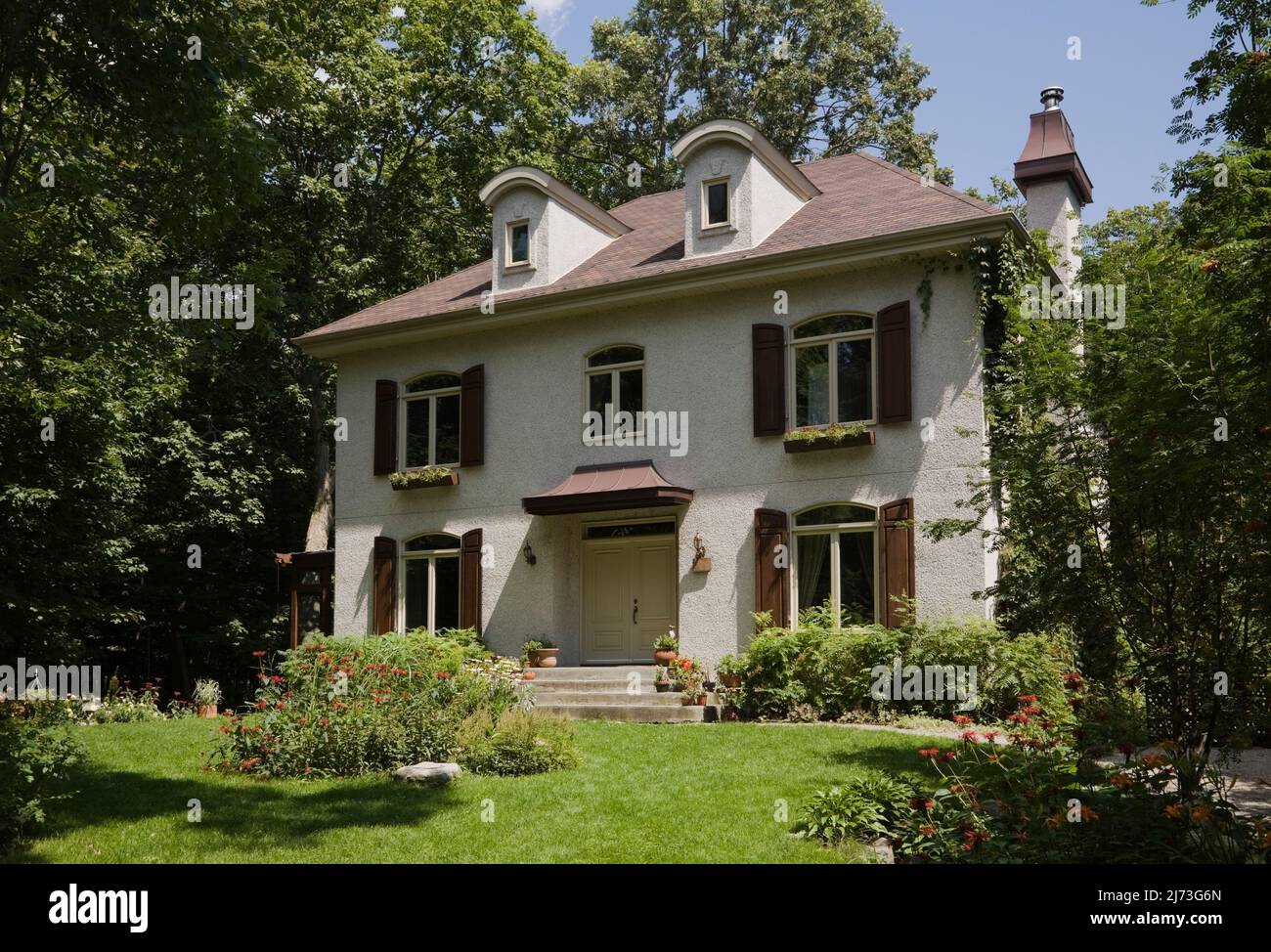 Two-storied French manor style home with landscaped front yard in ...
