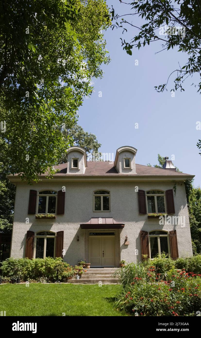 Two-storied French manor style home with landscaped front yard in ...