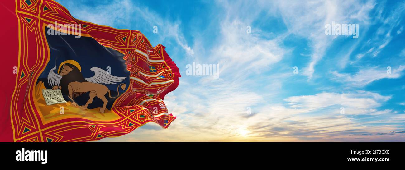 flag of Veneto, Italy at cloudy sky background on sunset, panoramic ...