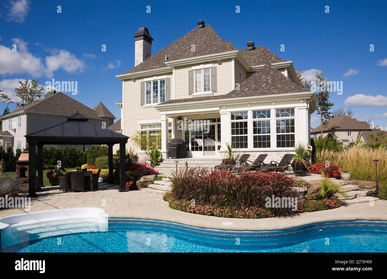 Upscale two-story home with landscaped backyard, patio furniture and in ...