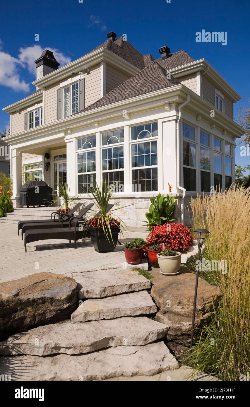 Upscale two-story home with landscaped backyard, patio furniture in ...