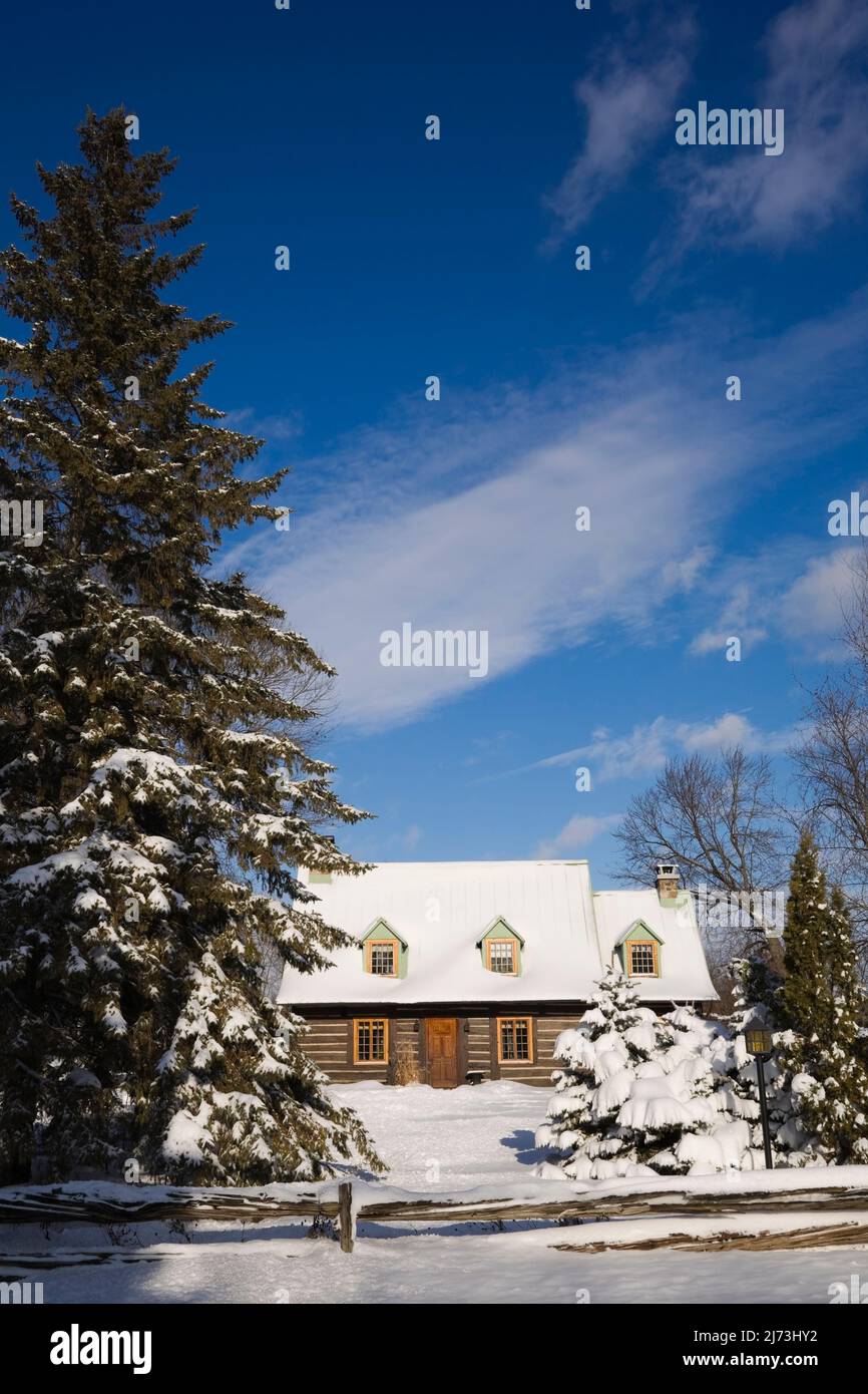 Old 1800s Canadiana style log home protected by rustic wooden fence in ...