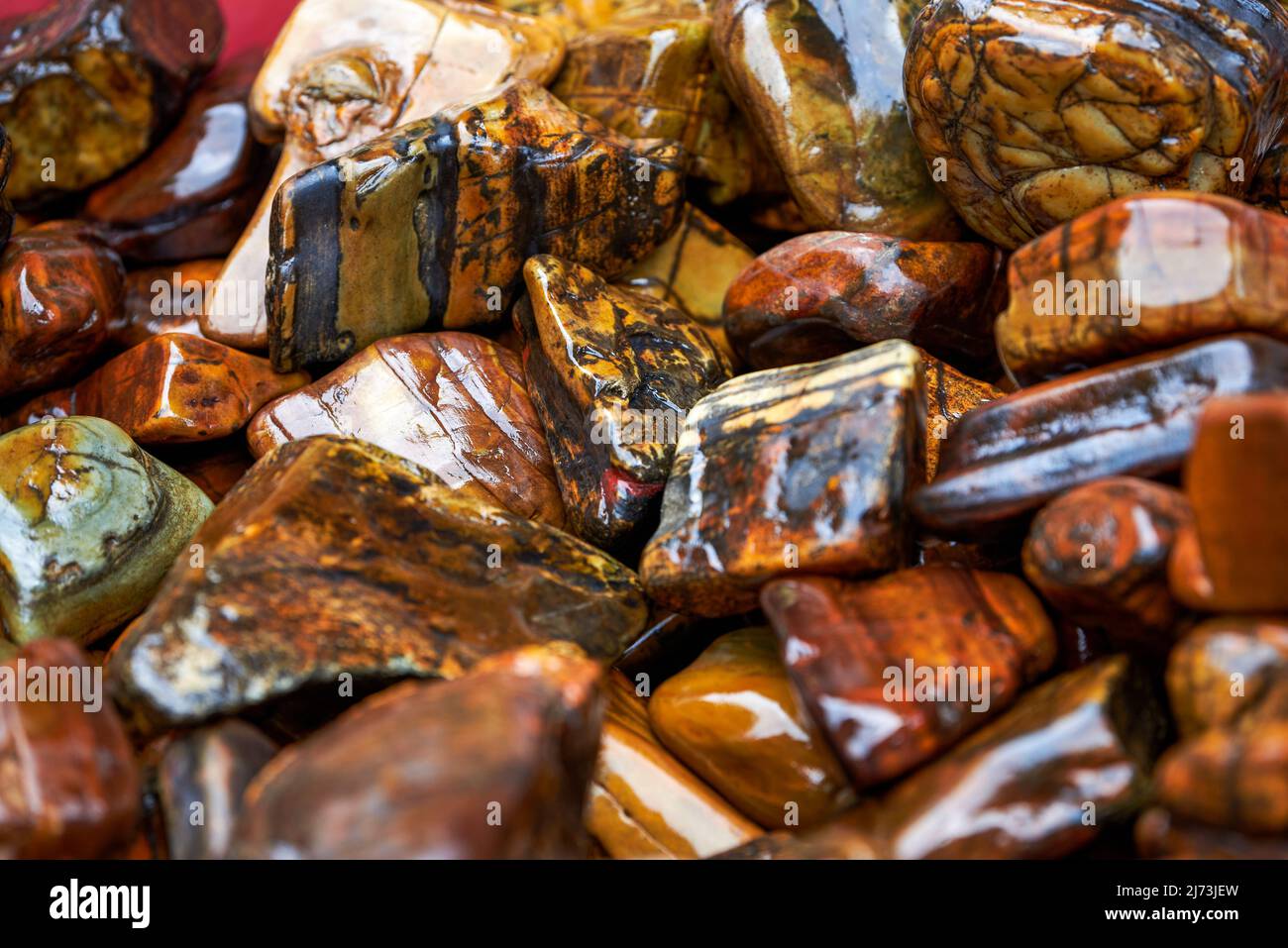 Close-up of shiny pile of pebbles Stock Photo - Alamy