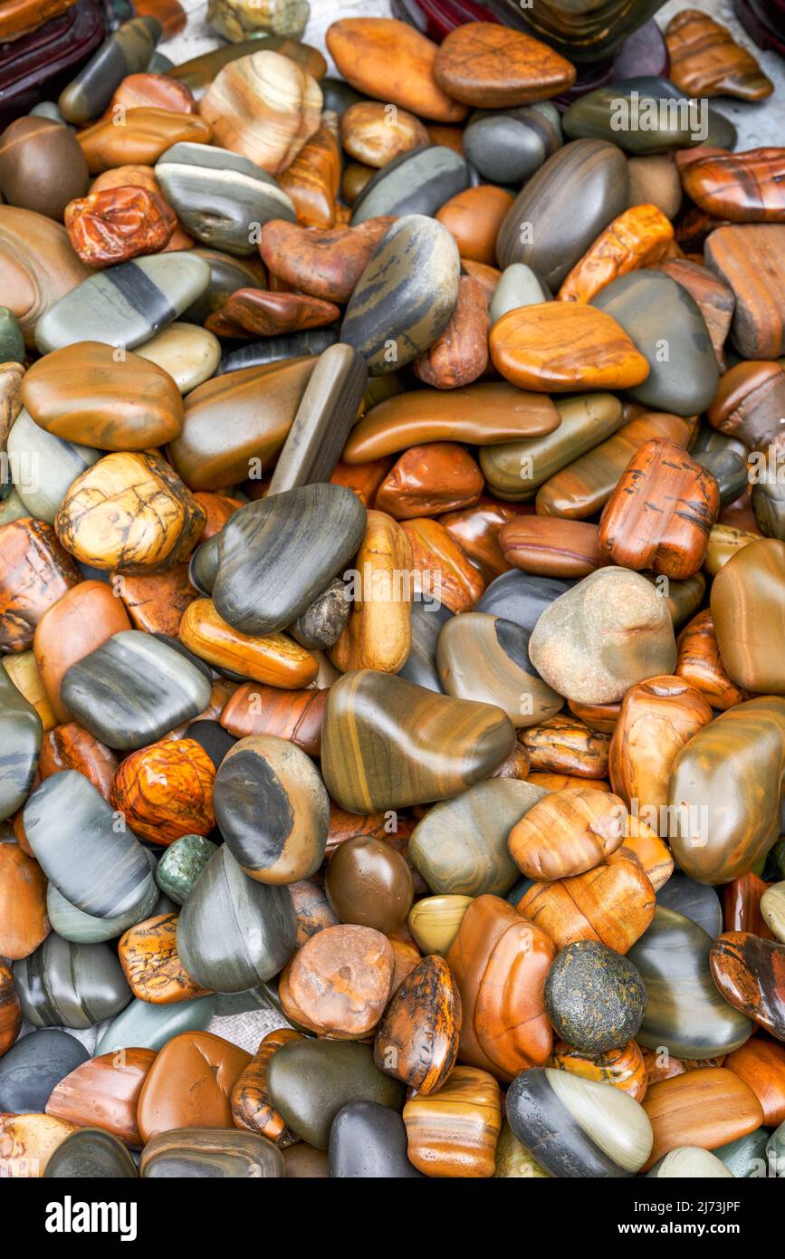 Close-up of shiny pile of pebbles Stock Photo - Alamy