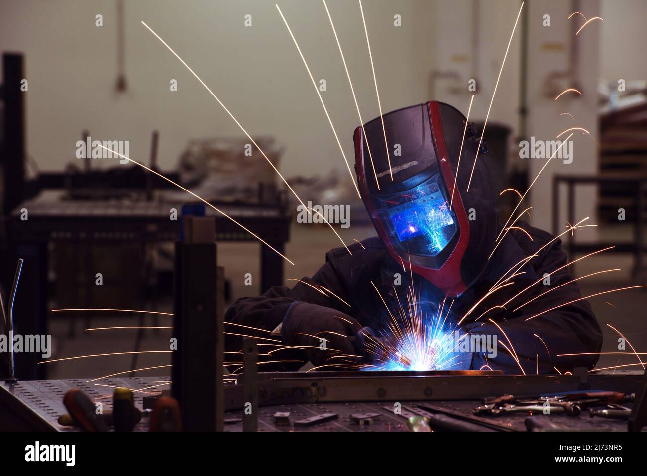 Professional Heavy Industry Welder Working Inside factory, Wears Helmet ...