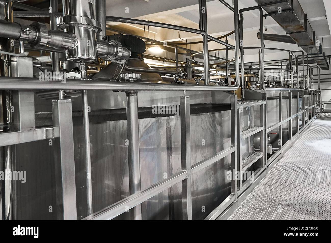 Metal ground near large cisterns for fermented milk products Stock ...