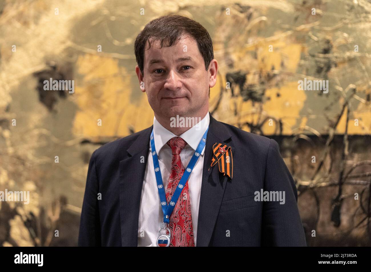 Russian ambassador Dmitry Polyanskiy seen with Georgian ribbon attached ...