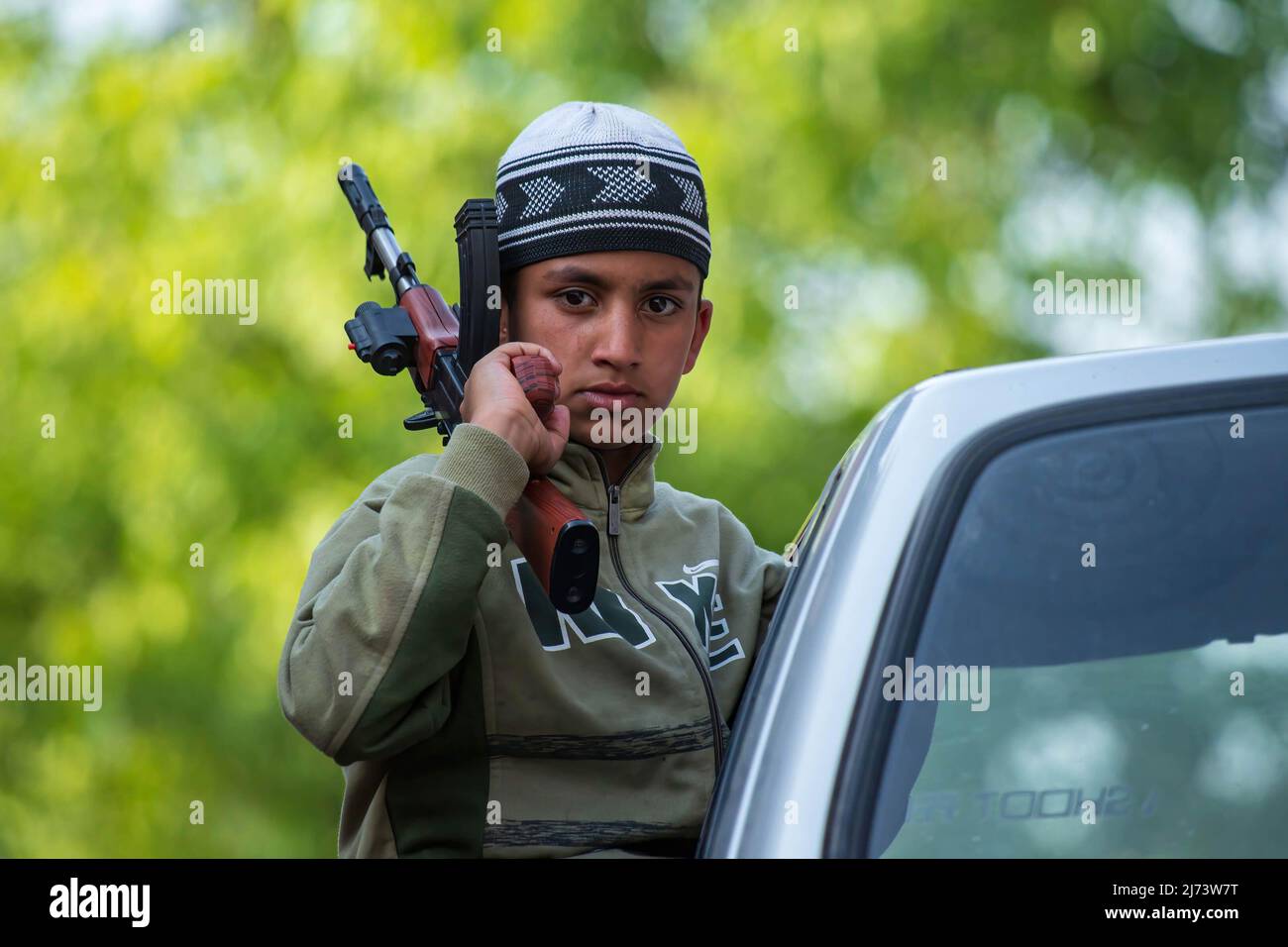 A Kashmiri Muslim boy poses as they play guns. As part of Eid-ul-Fitr ...