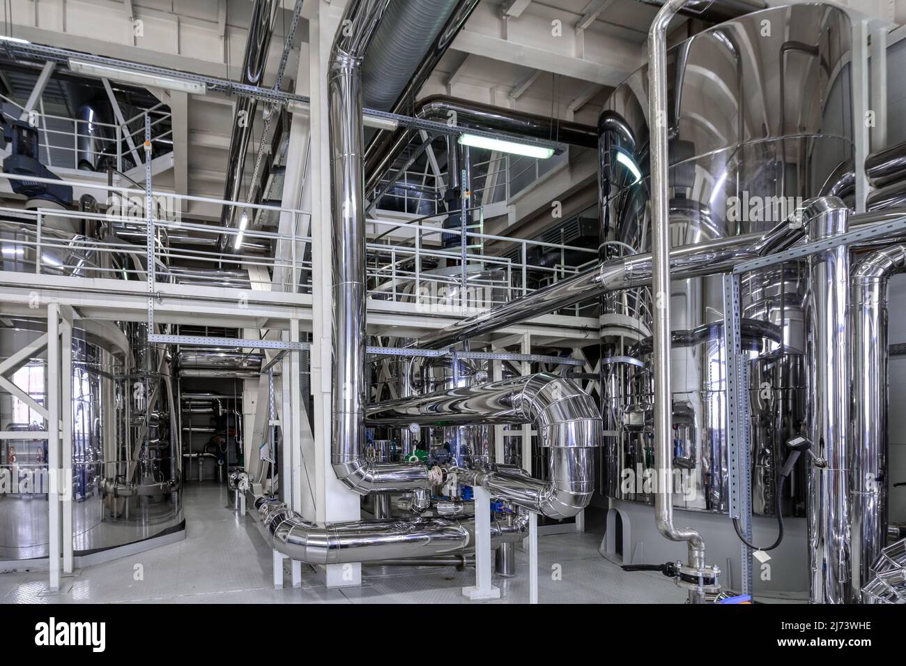 Complicated pipeline system in spacious workshop of plant Stock Photo ...