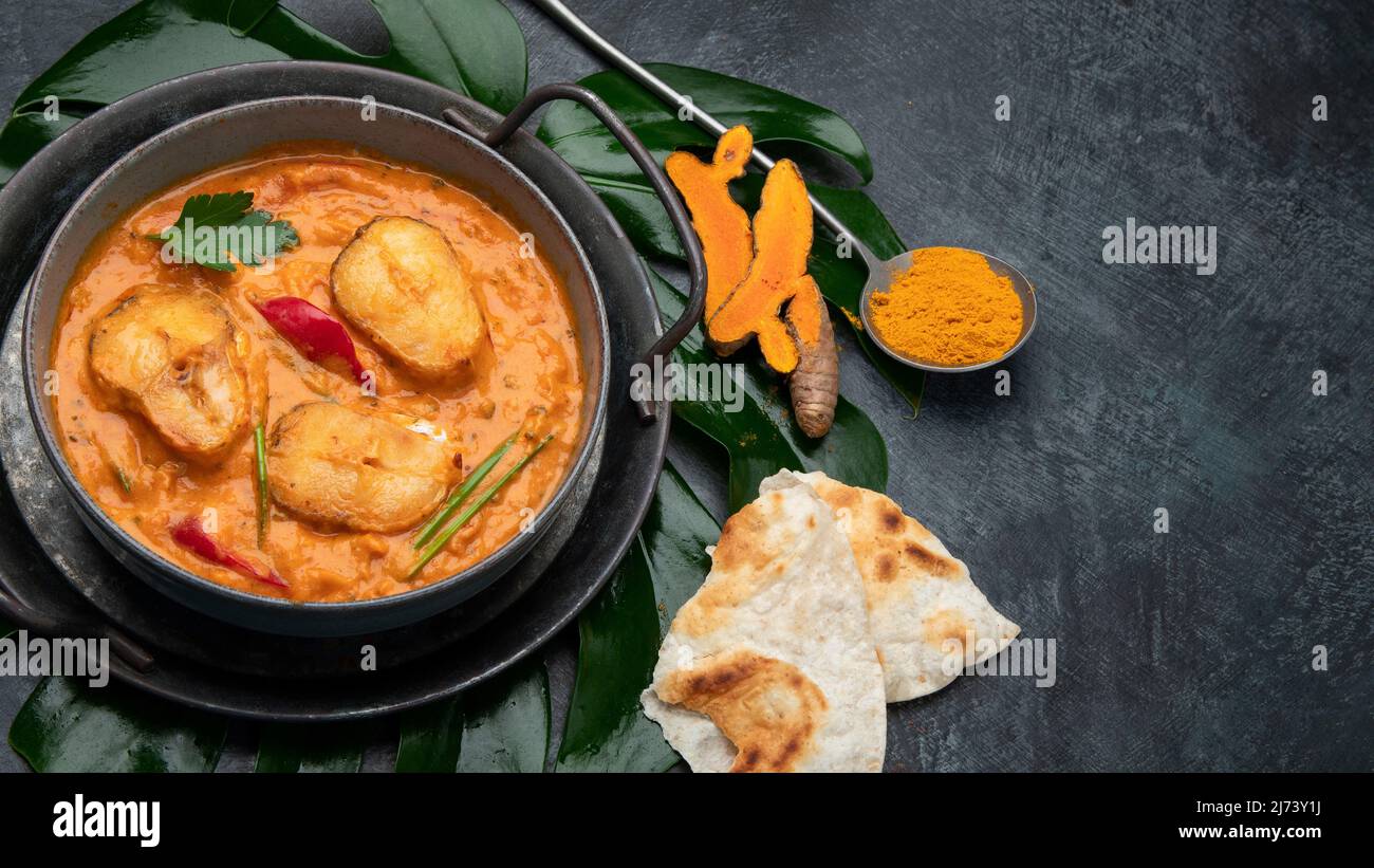 Kerala fish curry on dark background. Traditional food concept. Top ...