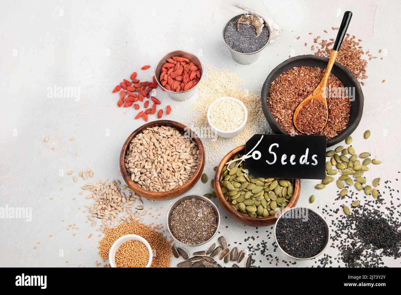Variety of edible seeds on light background. Cereal and grains. Healthy ...