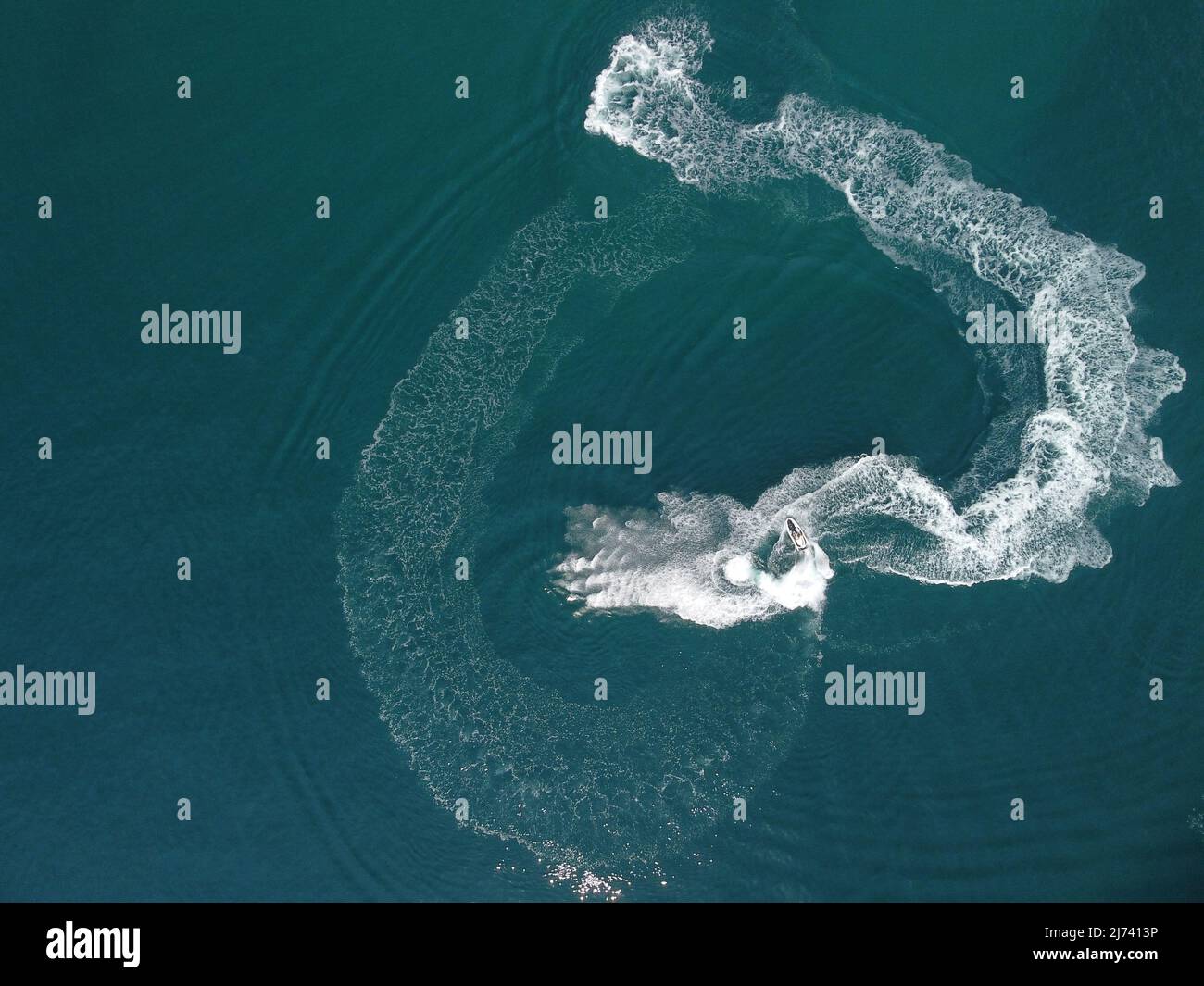 Aerial top down view of water foam trace with nice deep blue shade of ...