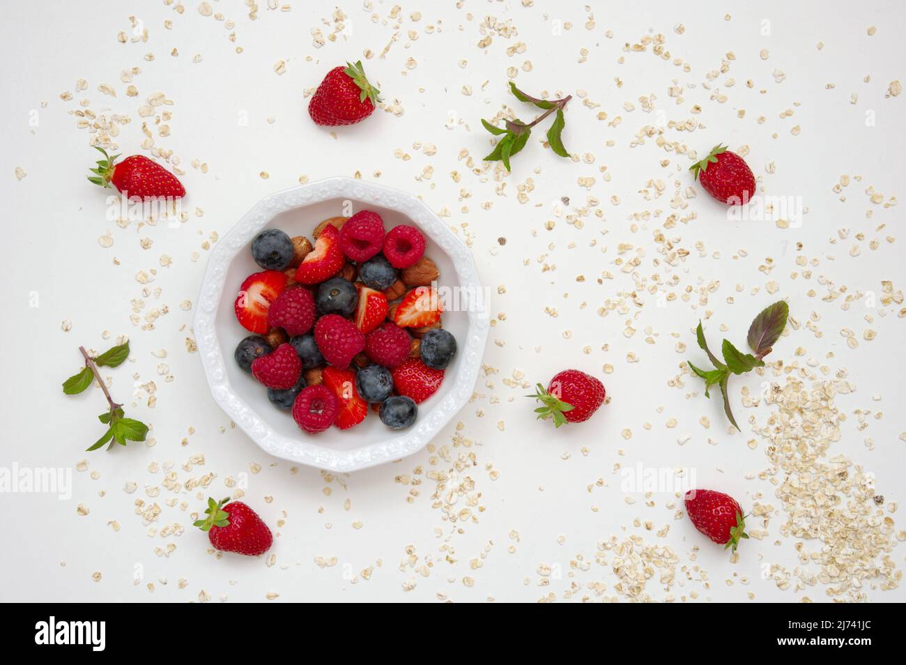 Flat lay of strawberries in white bowl against white background Stock ...