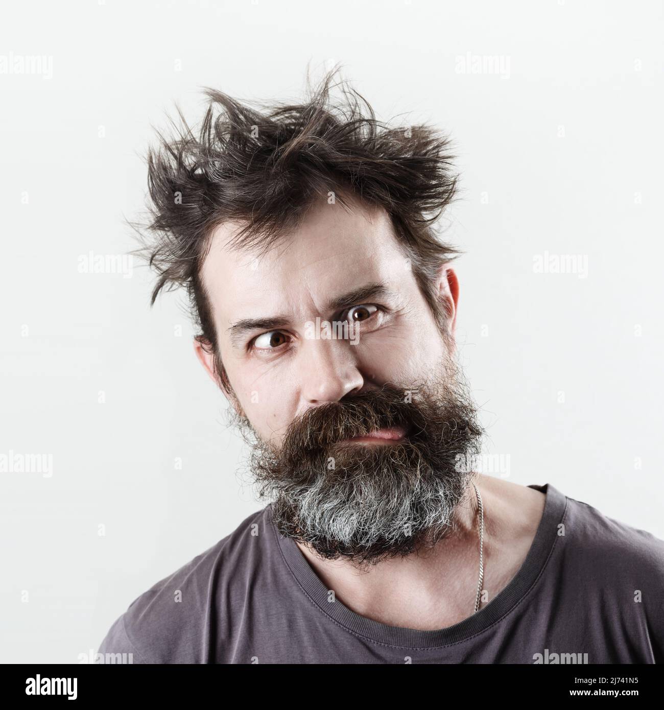 Man with stupid mug. Happy freak bearded shaggy man grimacing and ...