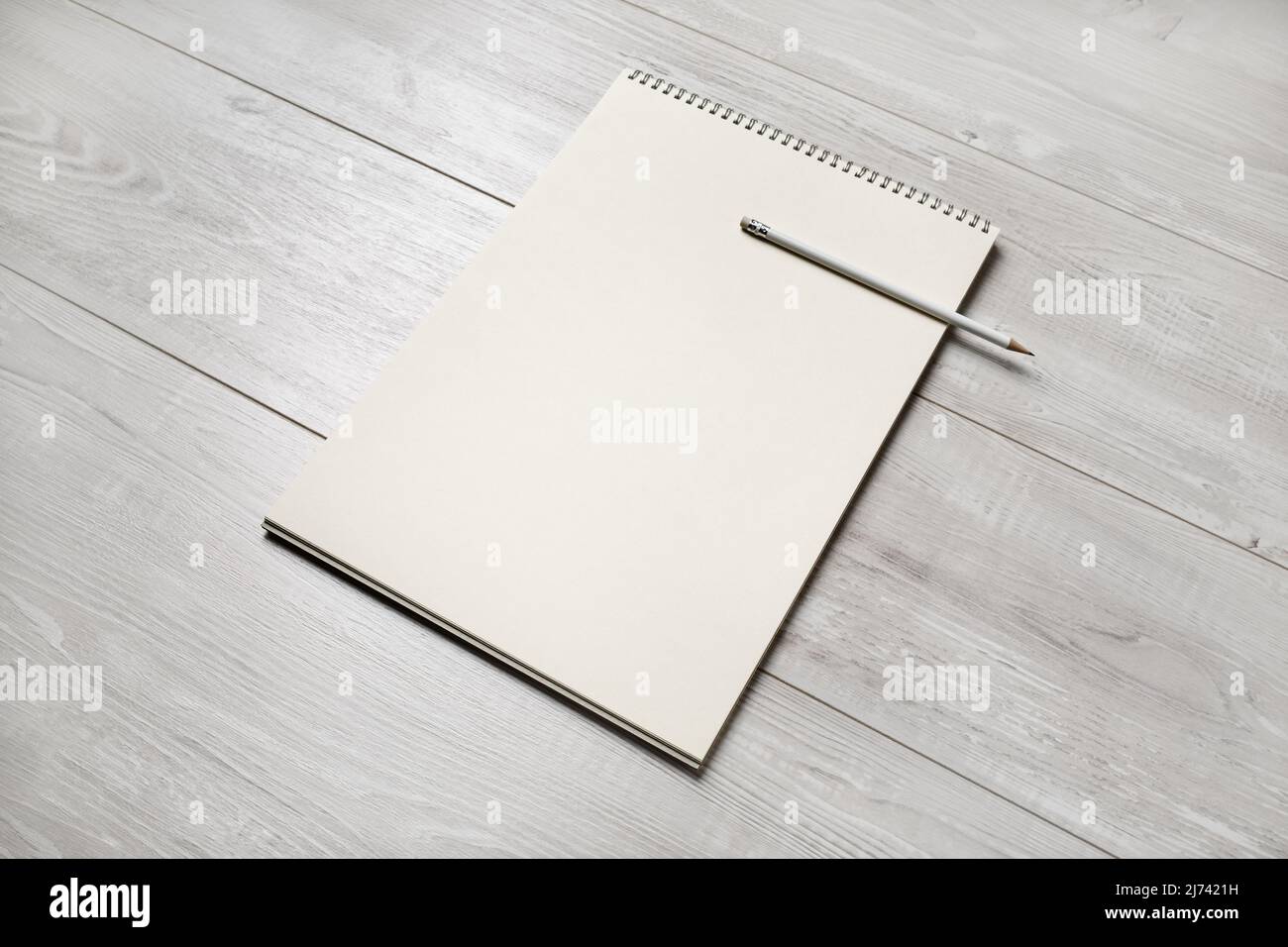 Photo of blank notepad and pencil on light wooden background. Blank ...