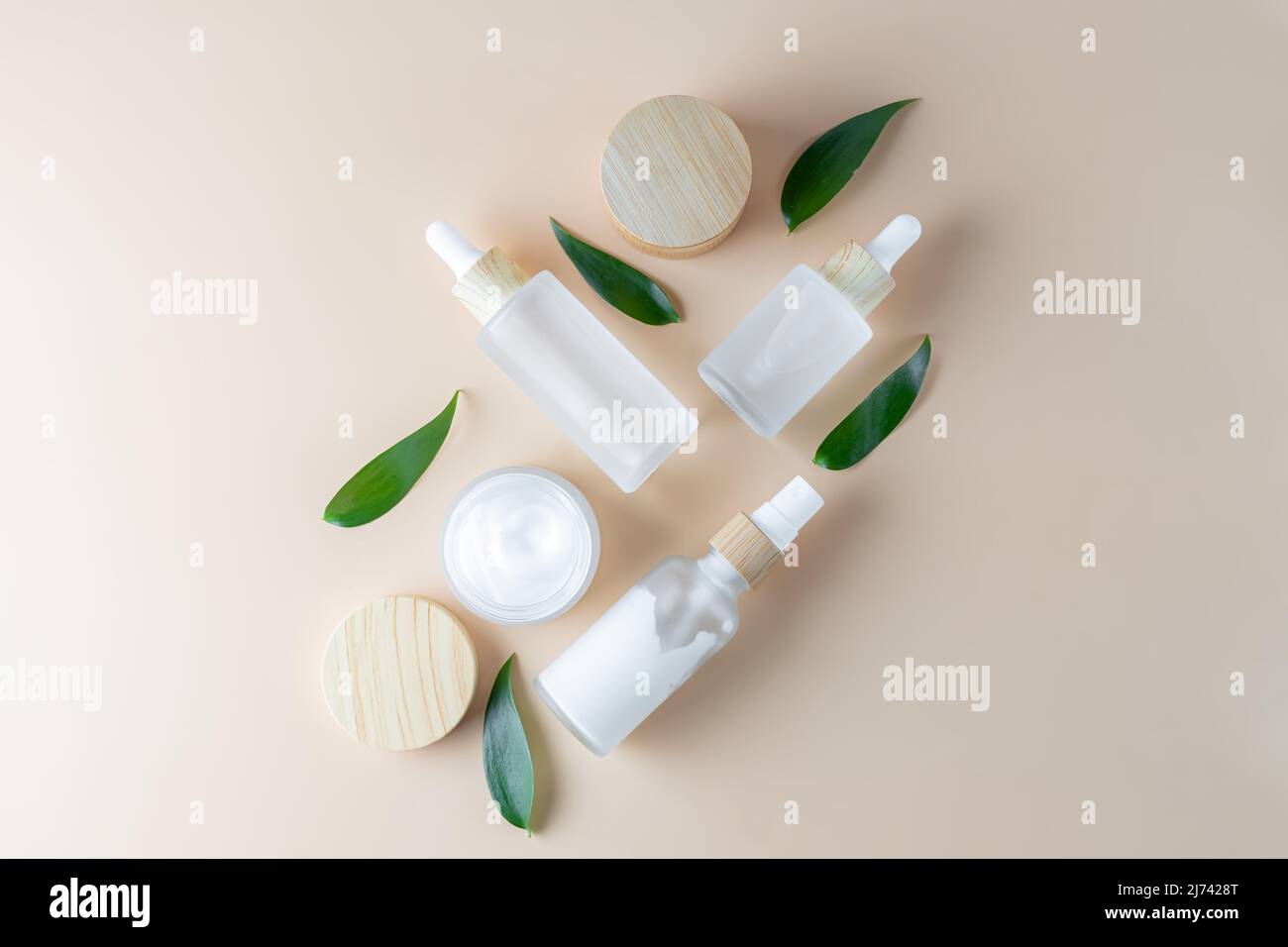Set of frosted glass cosmetic bottles on beige background. dropper ...