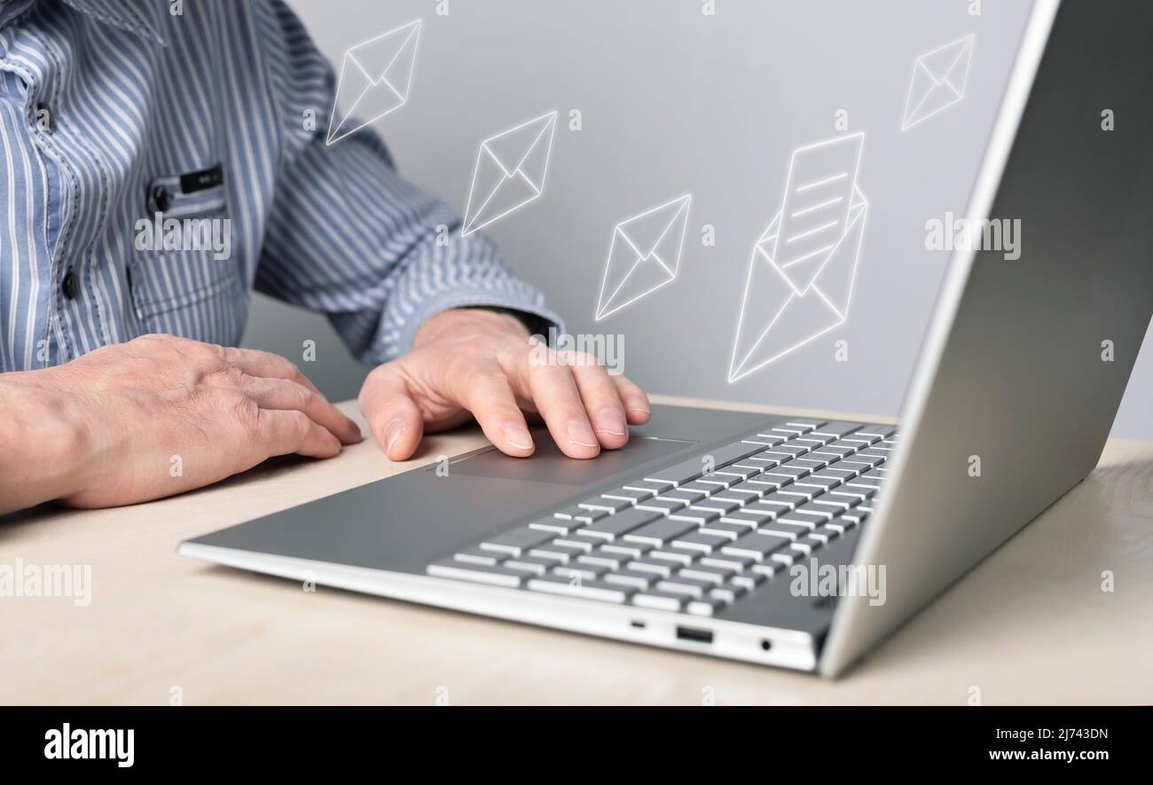 Business mail concept. Man working on laptop and sending letters to ...