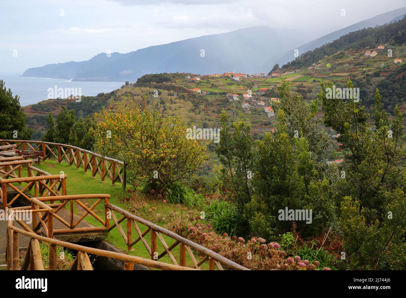 Green terraced fields along the valley of Janela and the village of ...