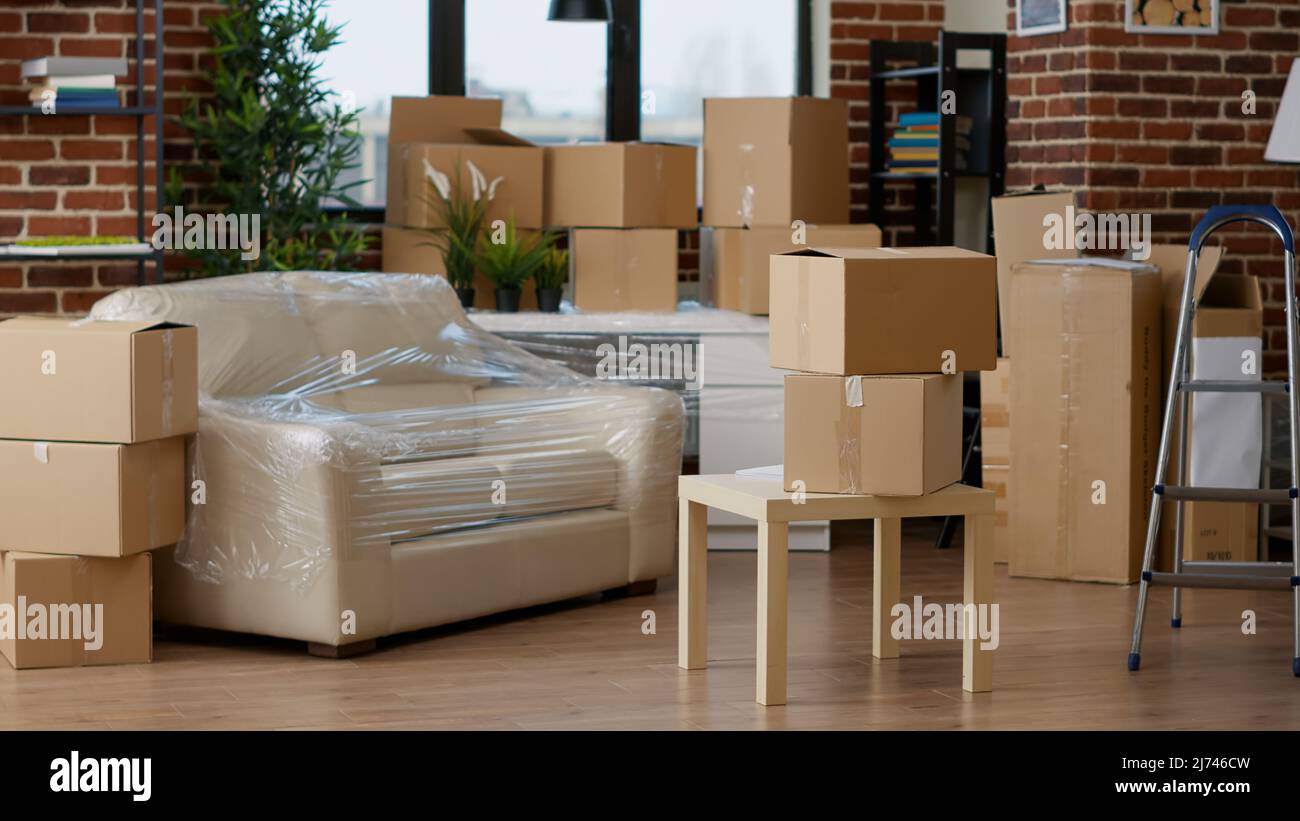 No people in empty living room apartment with carton boxes on stack ...