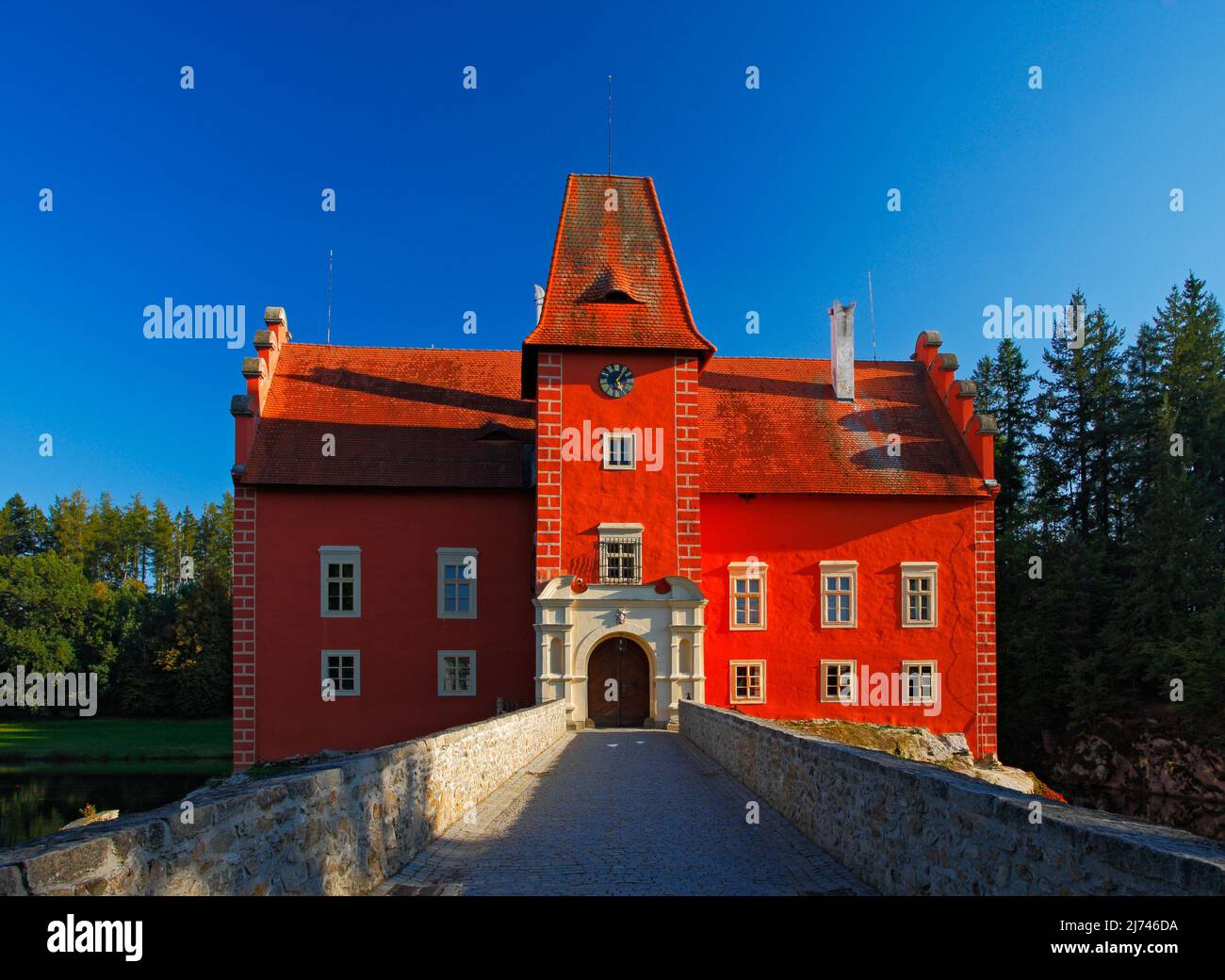 Fairy tale red castle on the lake with bridge, with dark blue sky ...
