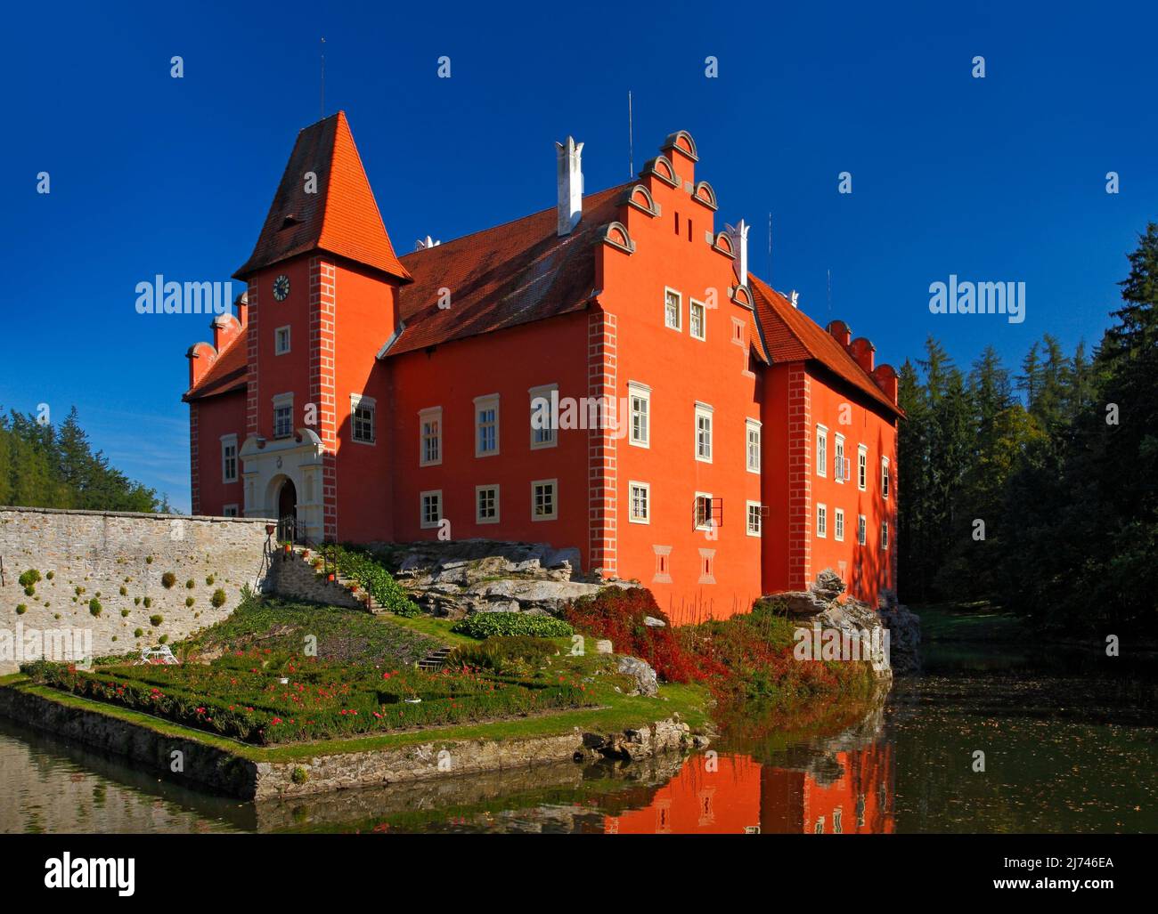 Fairy tale red castle on the lake, with dark blue sky, state castle ...
