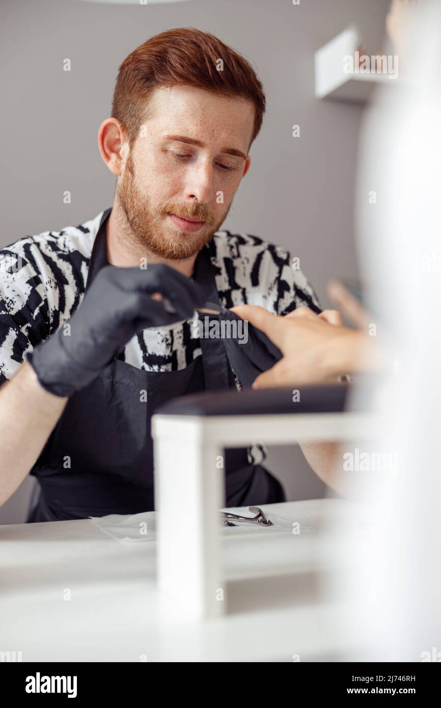 Professional manicure master working on nails in salon Stock Photo - Alamy