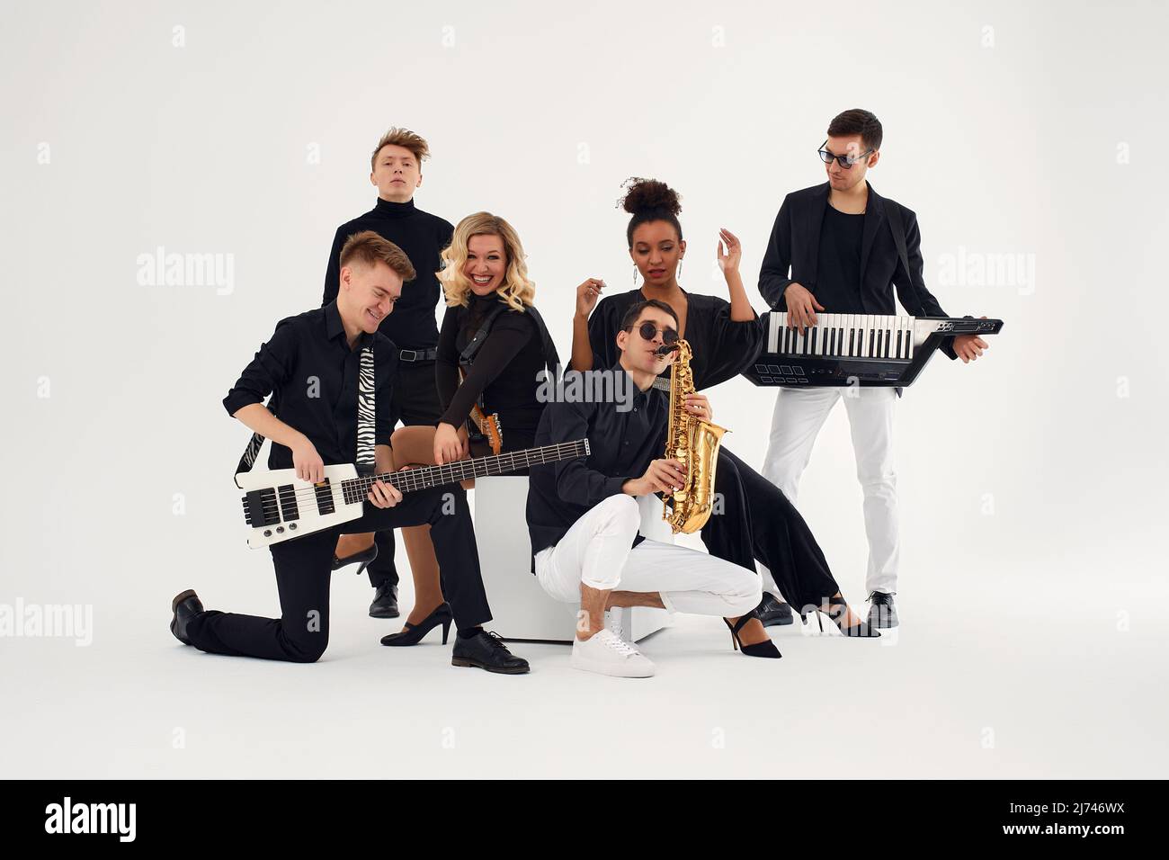 Portrait of diverse group of young people musical band playing with ...