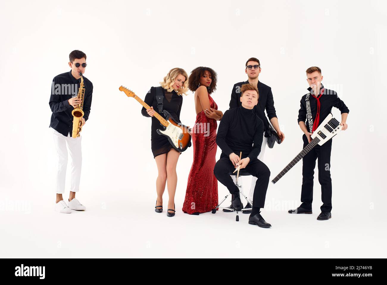 Portrait of diverse group of young people musical band playing with ...