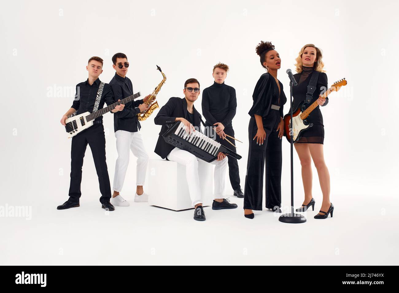Portrait of diverse group of young people musical band playing with ...