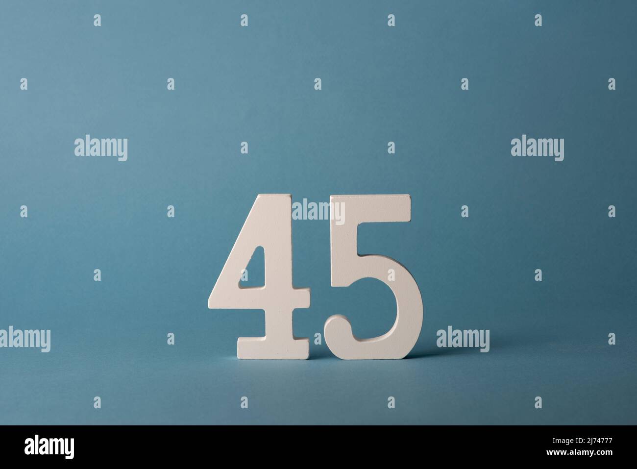 White wooden number forty-five 45 on blue background Stock Photo - Alamy