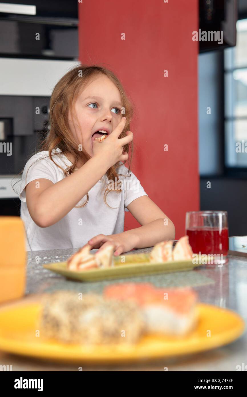 Cute smiling little girl with sushi on white background. Child girl ...