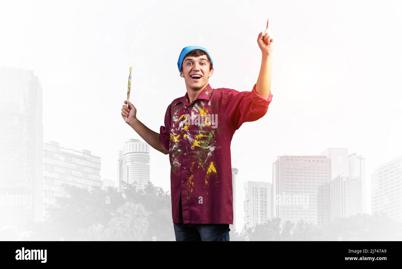 Young happy male artist painting hi-res stock photography and images ...
