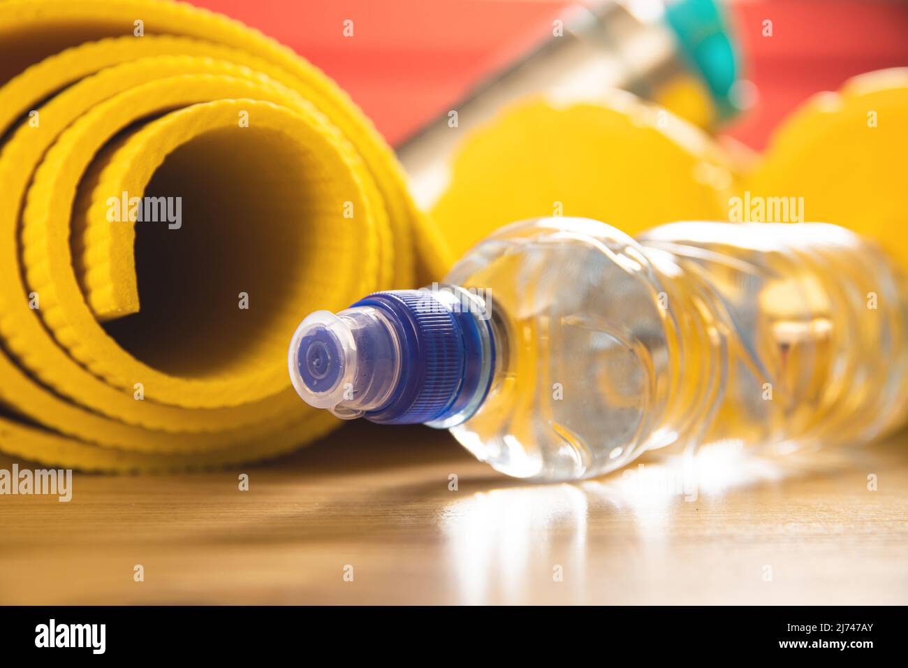 Bottle of still water and yellow fitness mat Stock Photo - Alamy