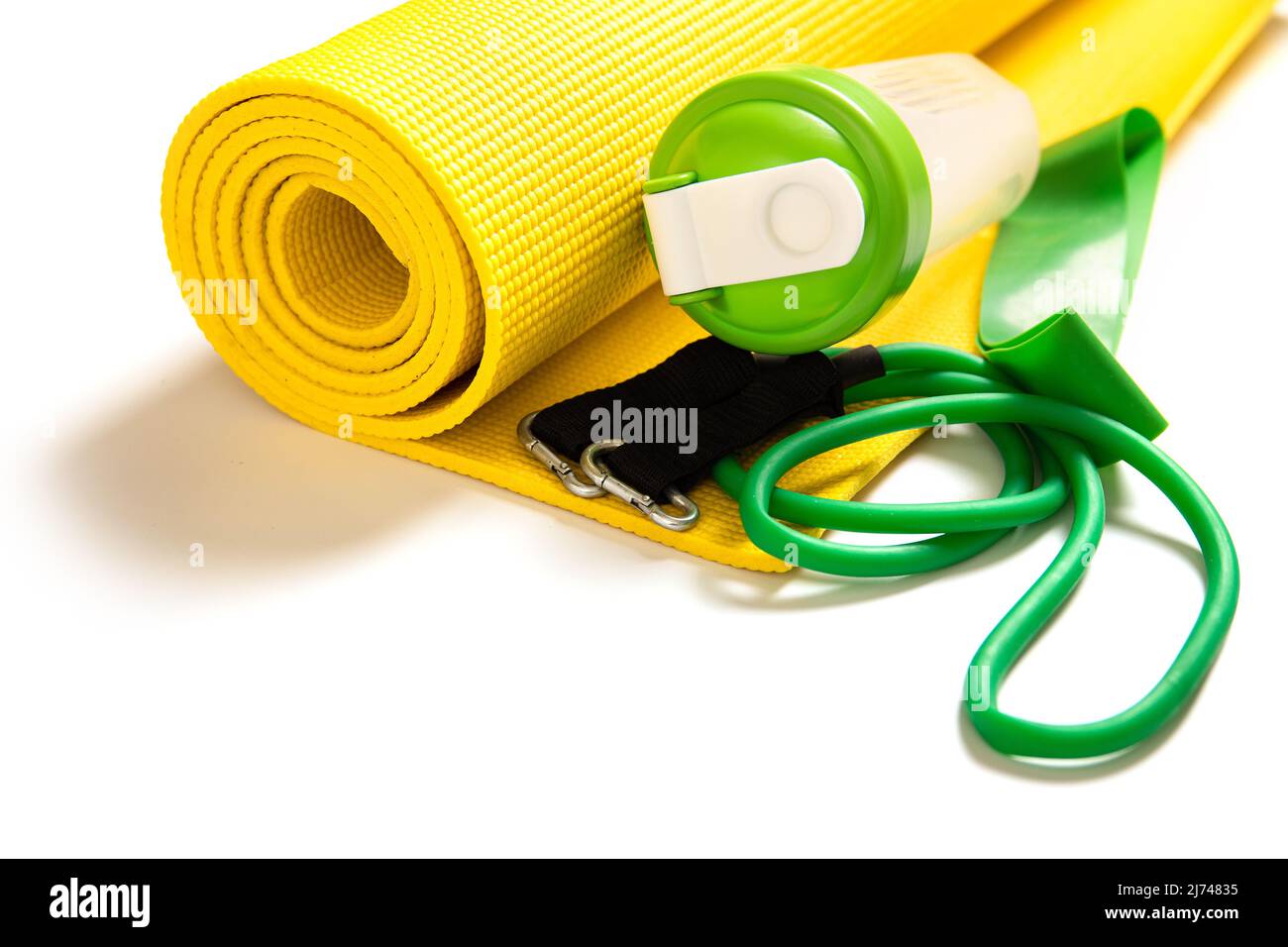 Protein shaker, fitness mat and rubber resistance bands on white ...