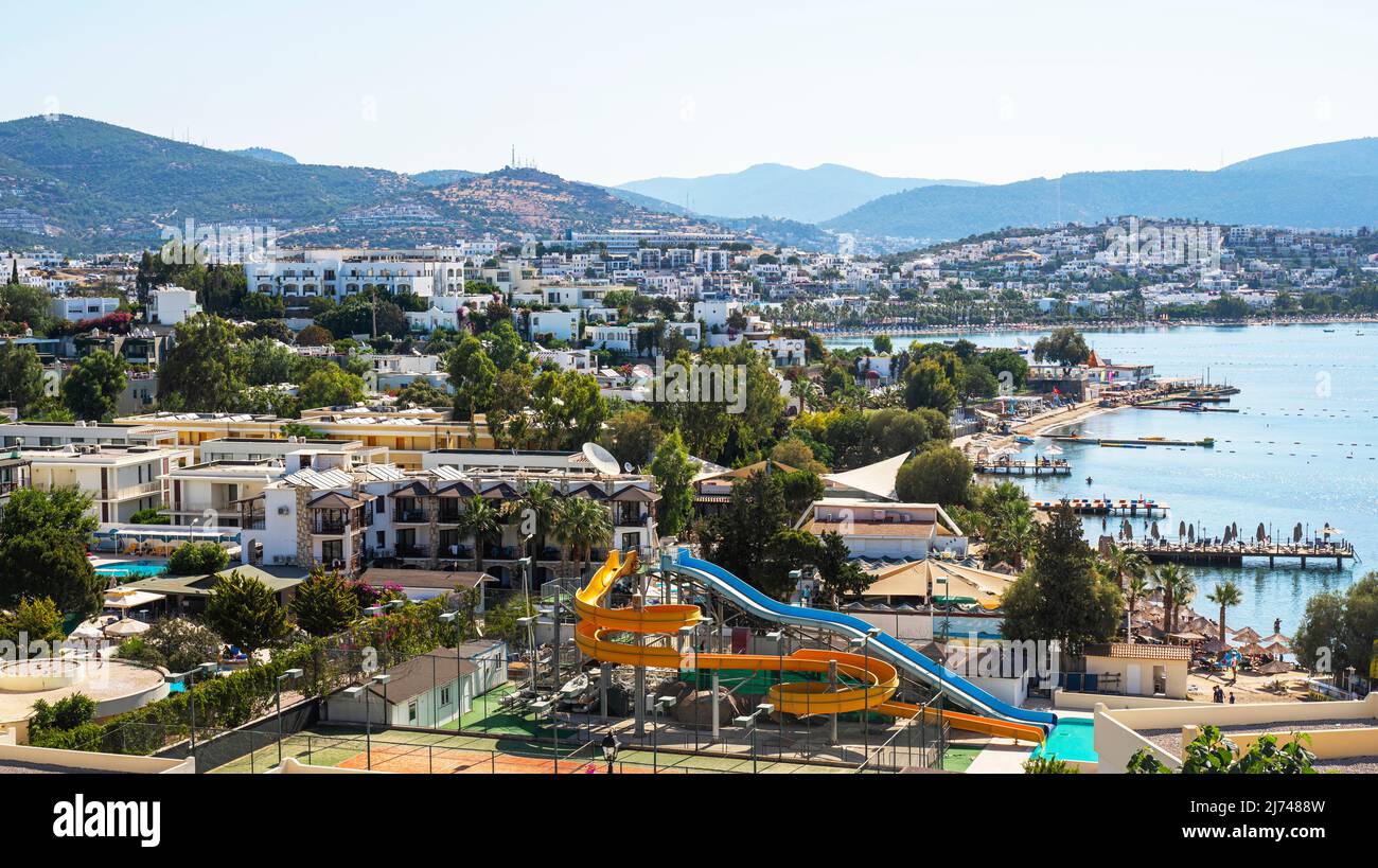 View of the sandy beach of the sea bay, in the background Bodrum ...