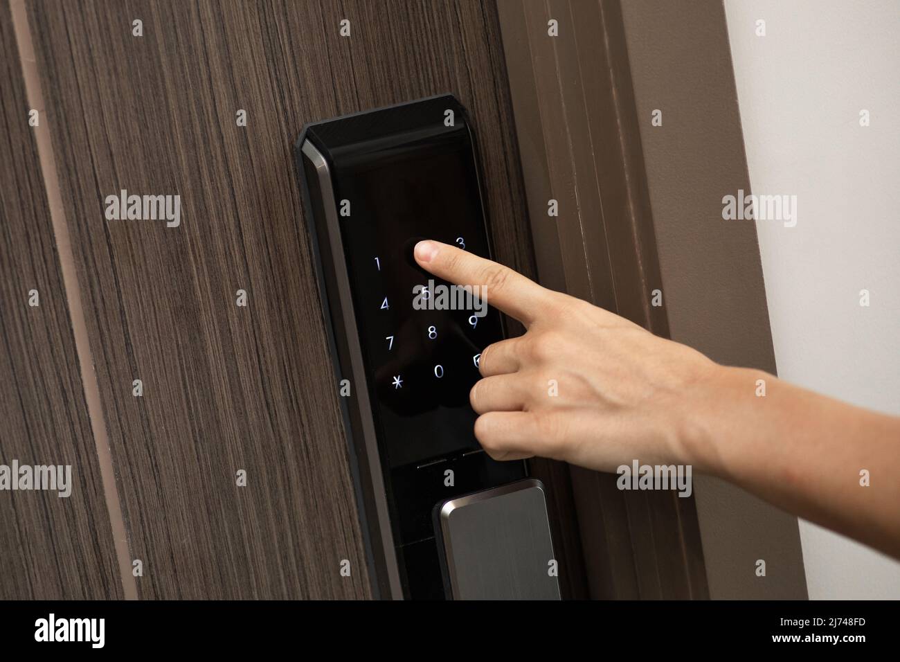 Hand and digital smart code lock into the modern apartment Stock Photo ...
