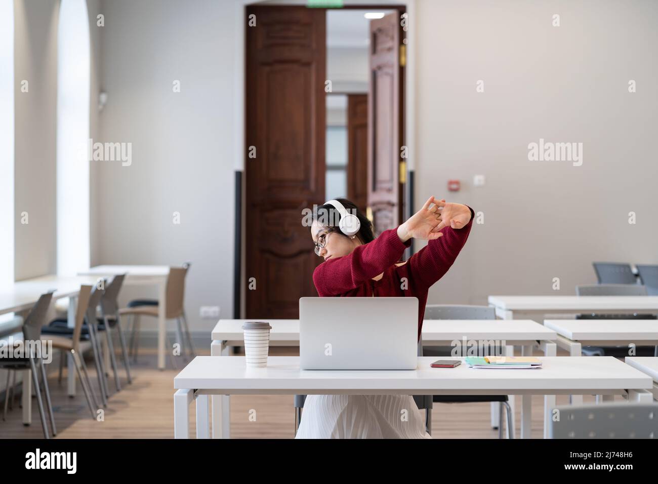 Tired asian female student sitting in library taking break during ...